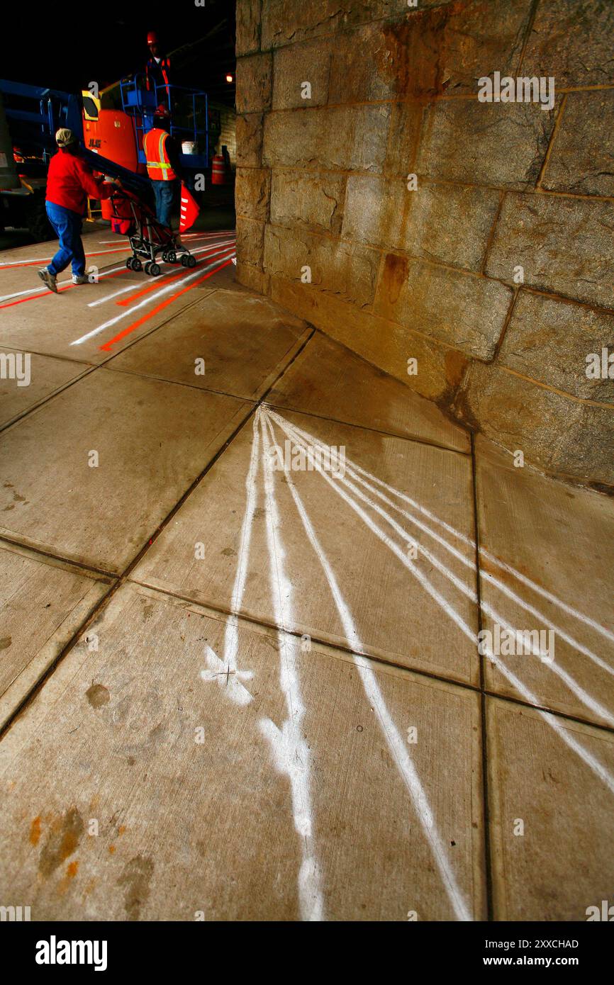 Construction workers marking up patterns on the pavement under Brooklyn ...
