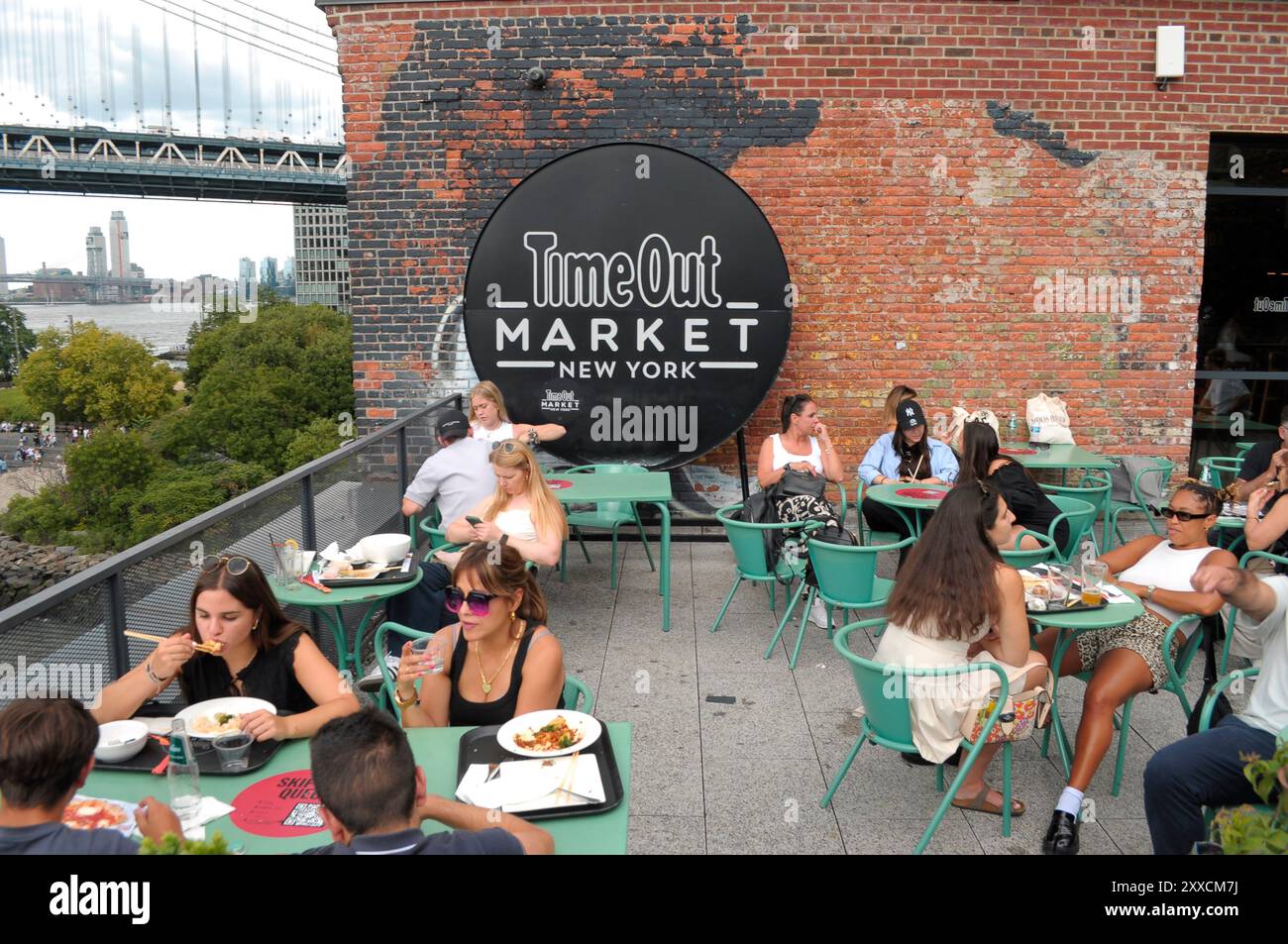 People are seen at a restaurant on a rooftop in Dumbo in Brooklyn, New ...