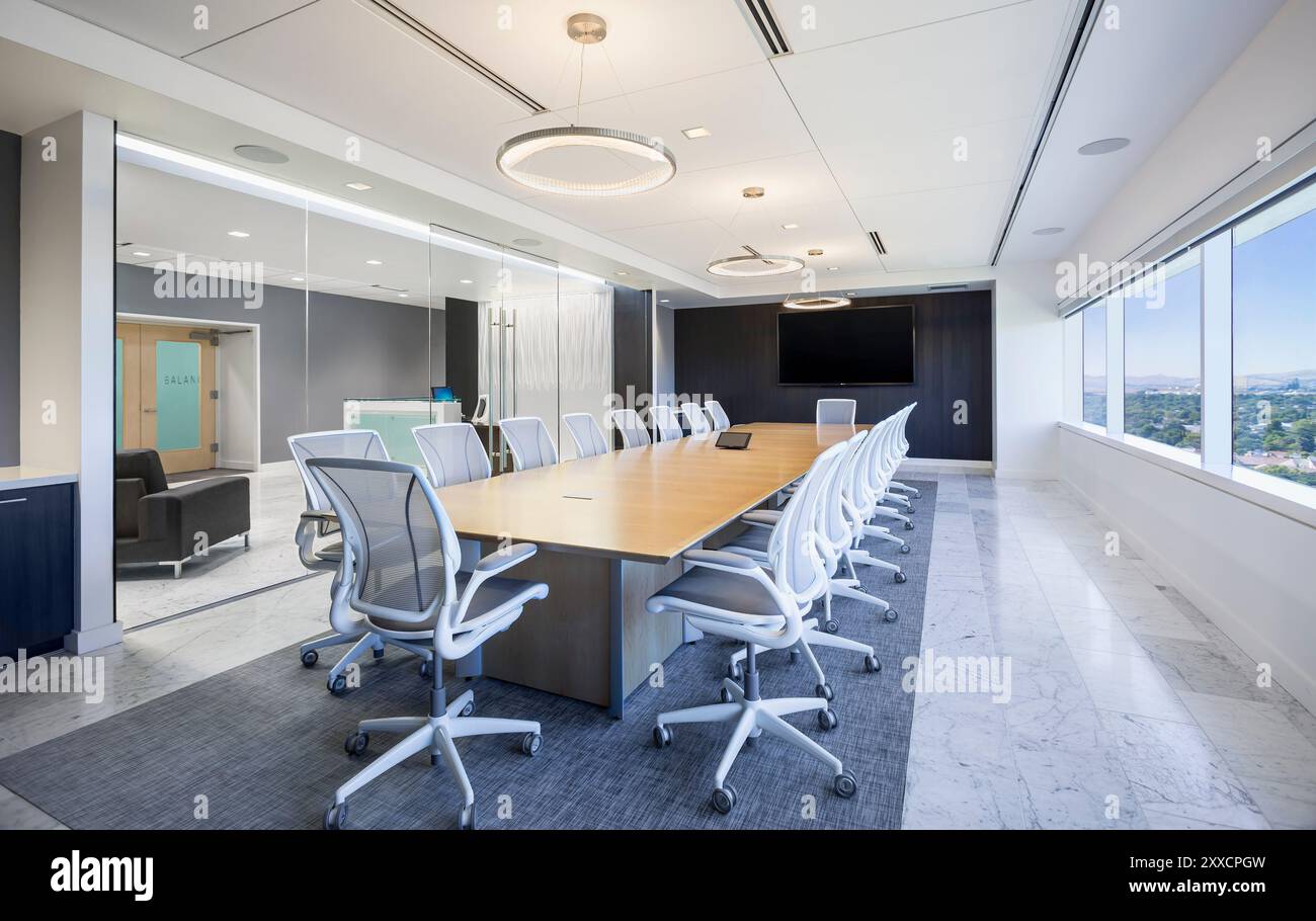 Large black and white conference room with view out glass wall to ...