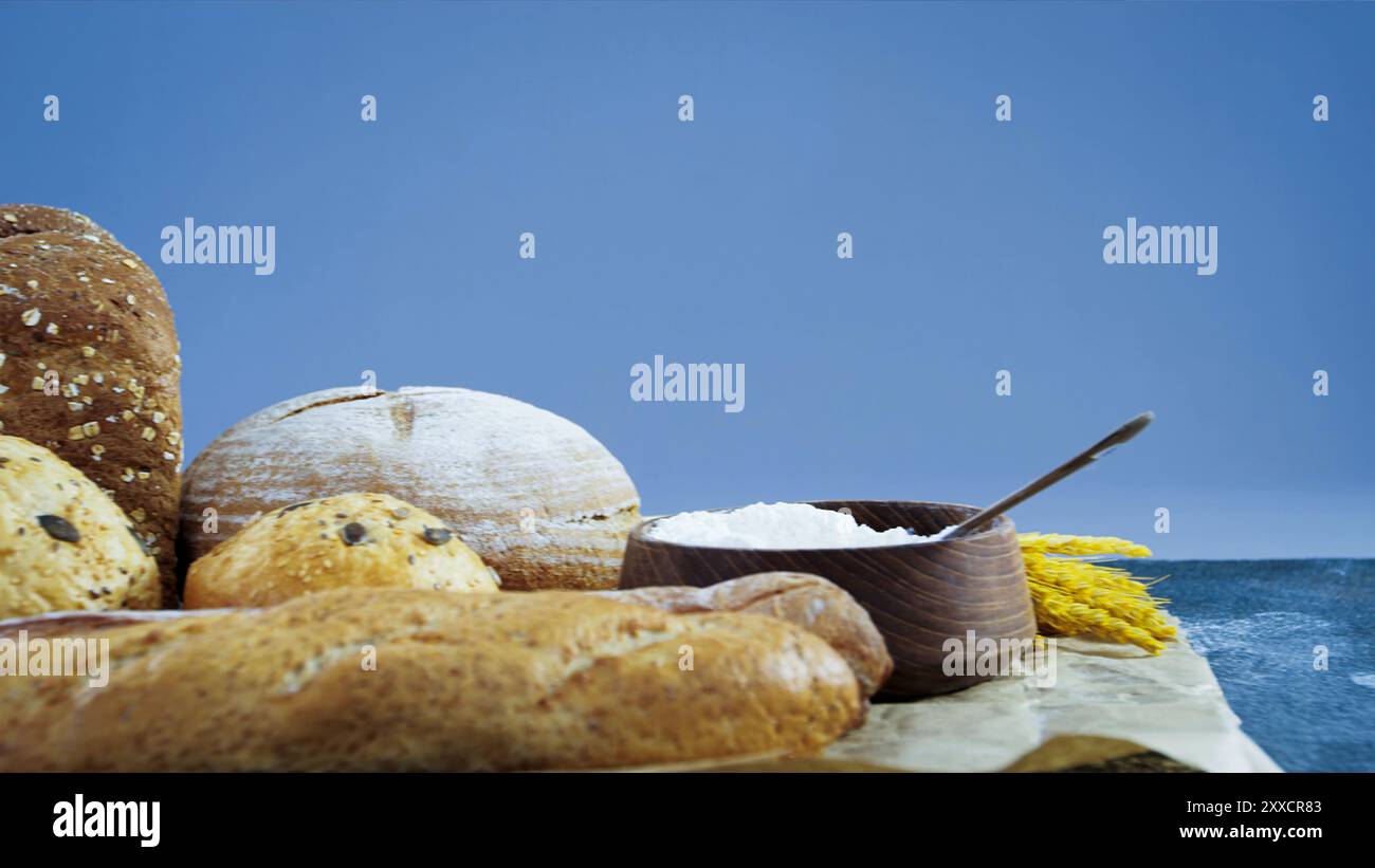 Different types of bread in a rustic basket isolated on a blue ...