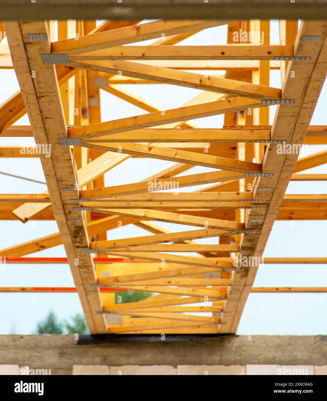 Construction site displaying a wooden truss structure under development ...