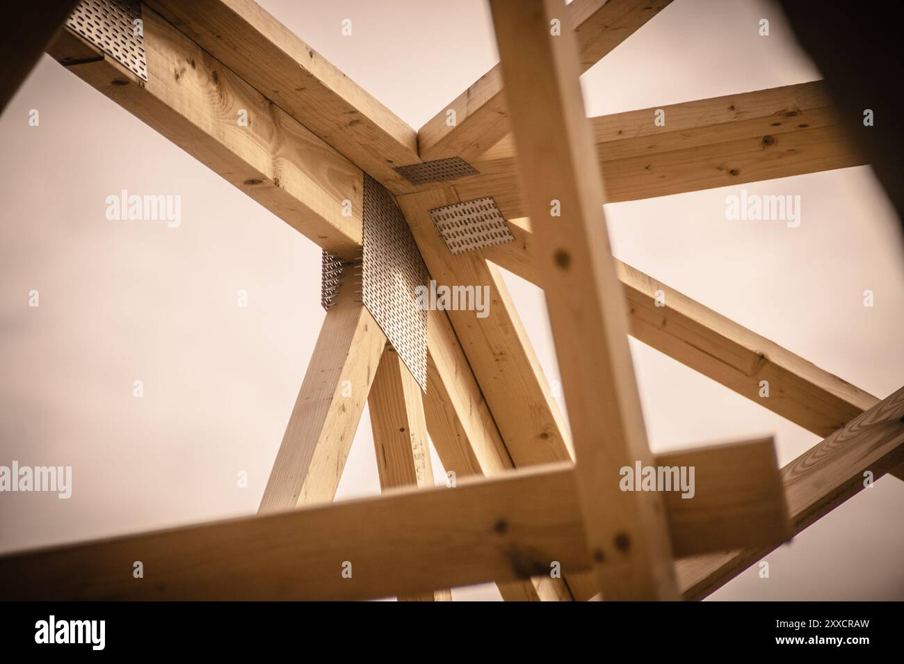 Wooden beams create a geometric shape from a unique angle, showcasing ...