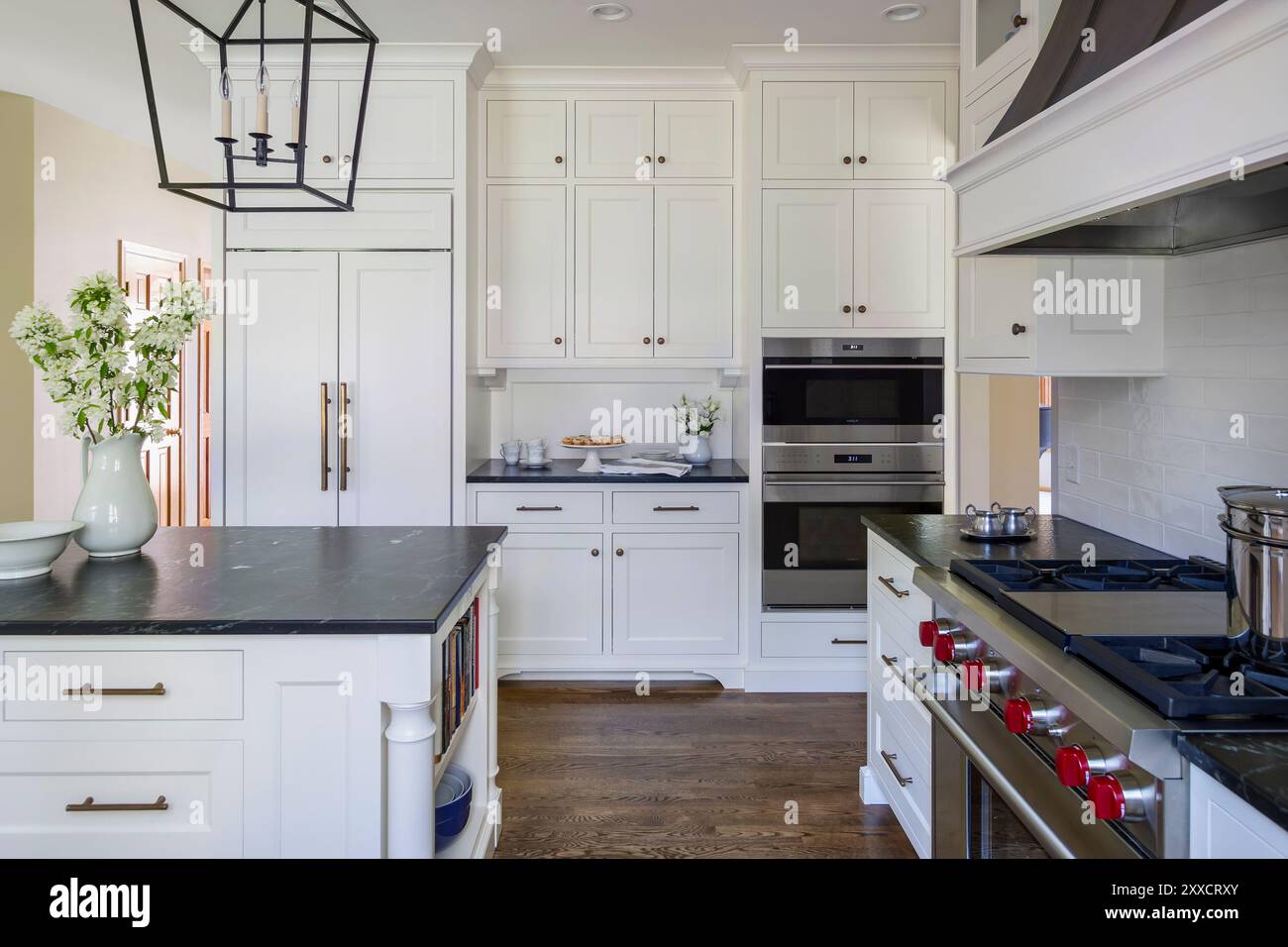 One wall of white kitchen showing Wolf range and wall ovens and Sub ...