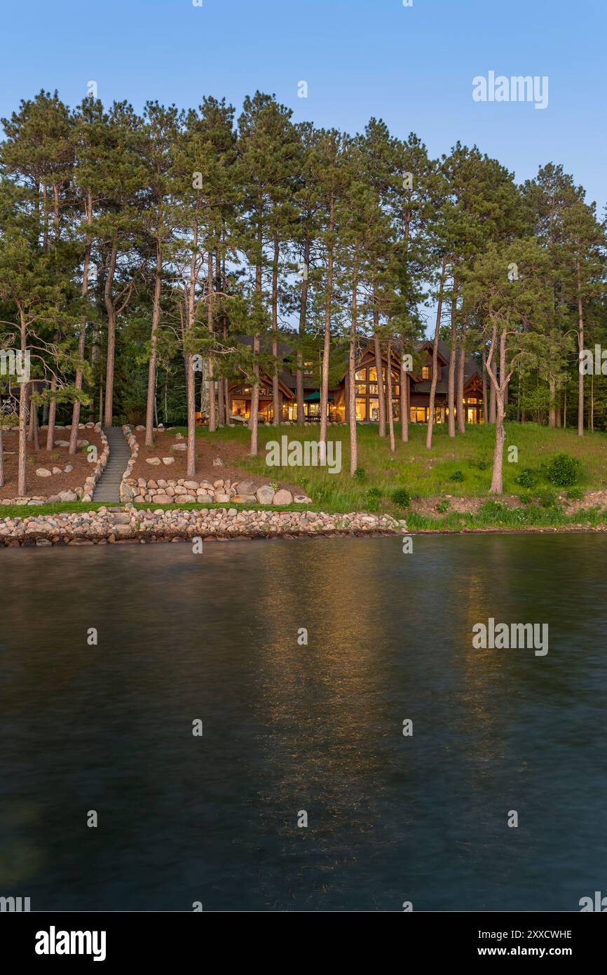 Lakeside home hidden behind tall pine trees hi-res stock photography ...