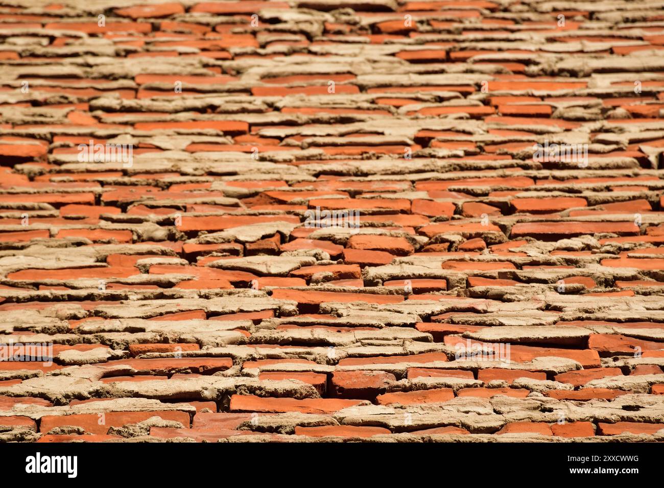 Backside of a brick wall. Uneven brick layout with mortar oozing out ...