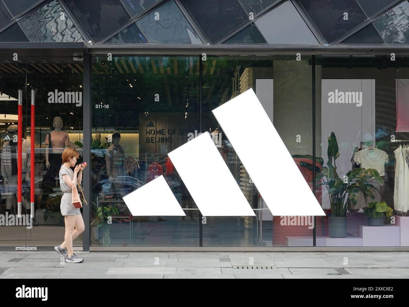 BEIJING, CHINA - AUGUST 18, 2024 - People pass by the Adidas flagship ...