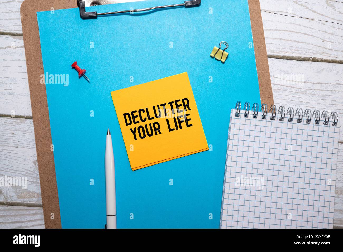 Pink office desk with keyboard and notebook, text DECLUTTER YOUR LIFE Stock Photo - Alamy