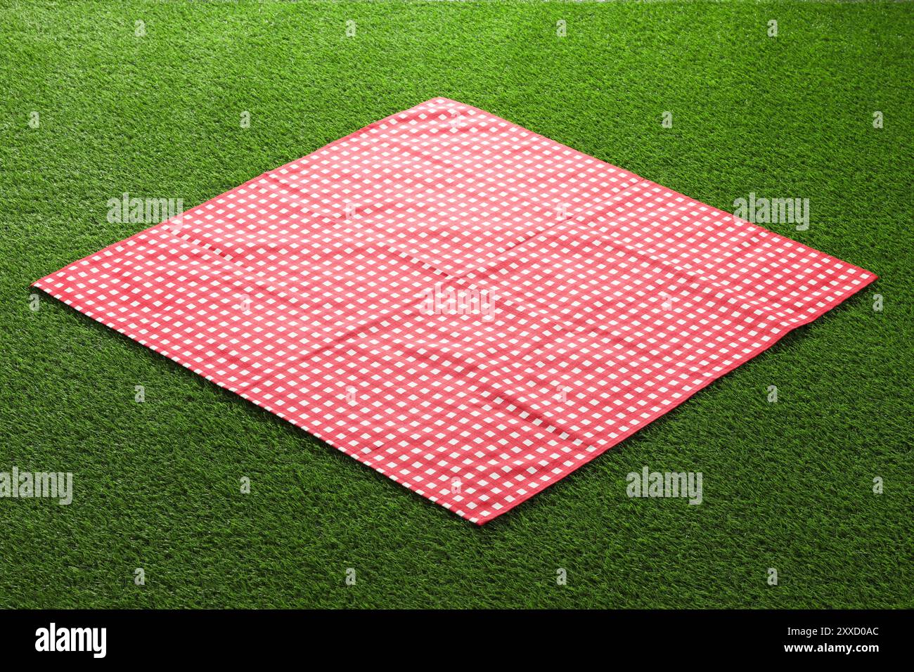 Red checkered picnic tablecloth on green grass Stock Photo - Alamy