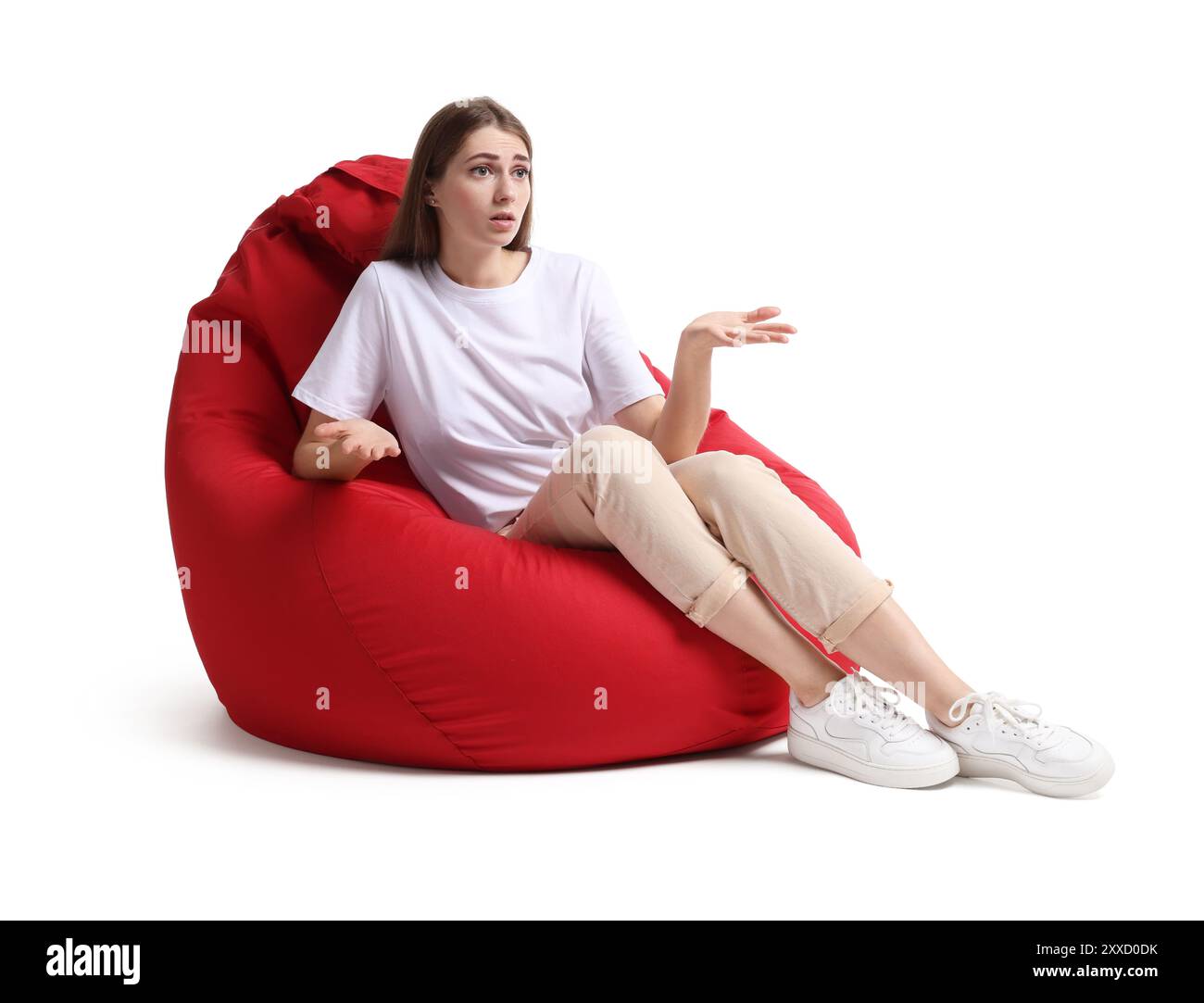 Emotional woman sitting on red bean bag chair against white background ...
