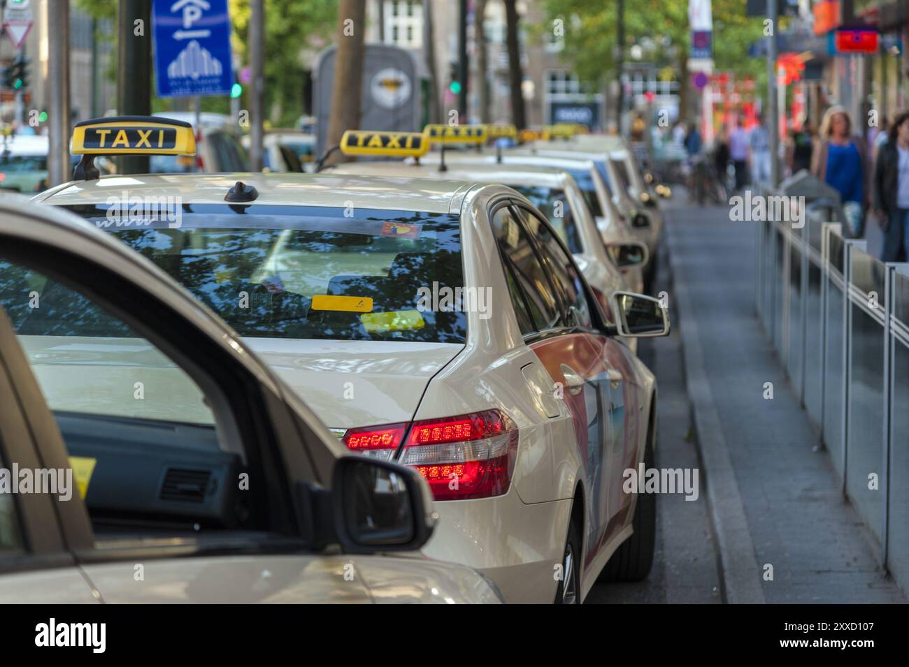 Taxis stand in a row at a taxi rank Stock Photo - Alamy