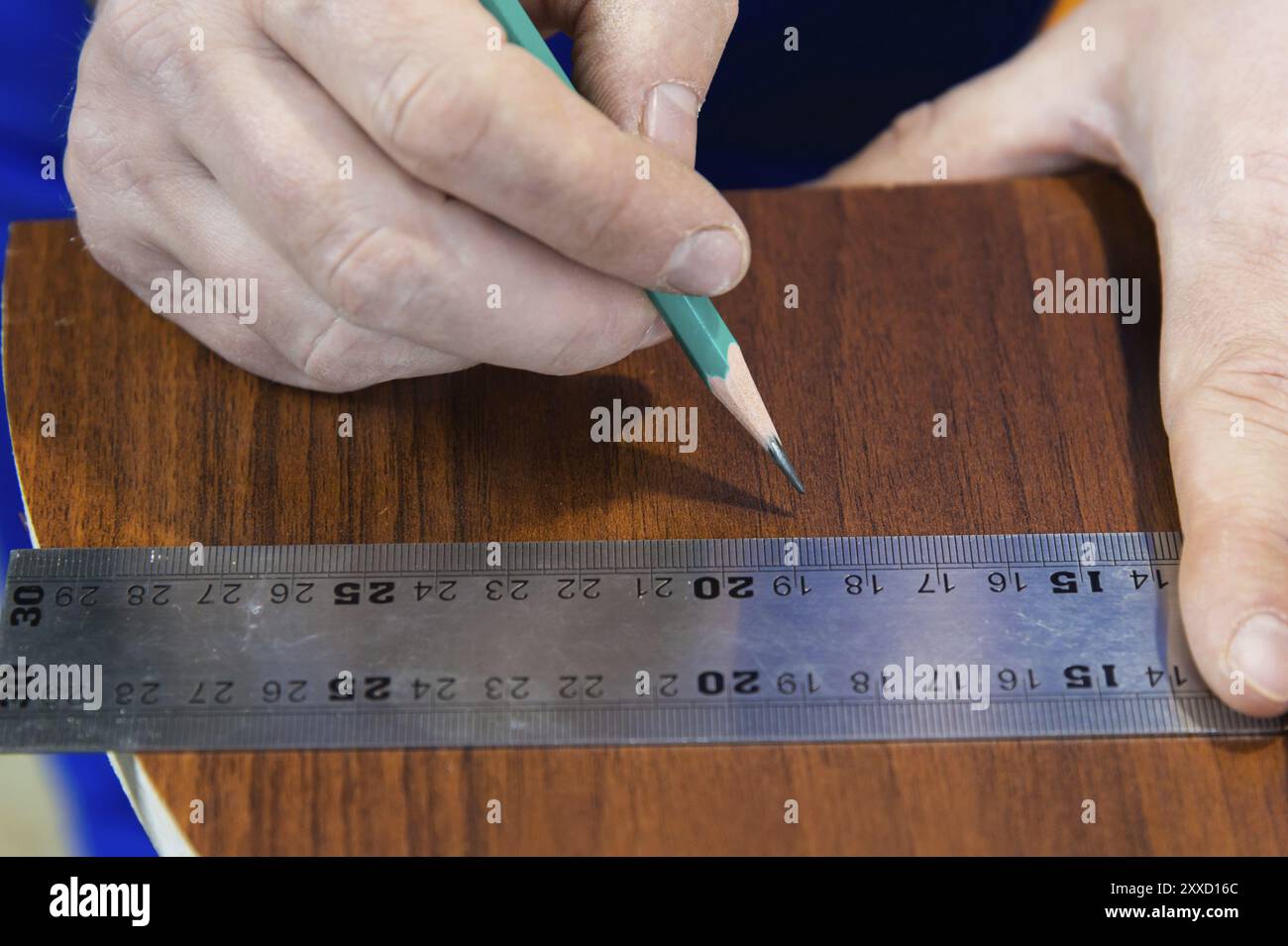 Close-up Men's hands draw a pencil on the ruler with a sub-standard ...