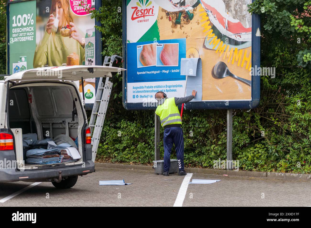 Poster artist pastes over a billboard again Stock Photo - Alamy