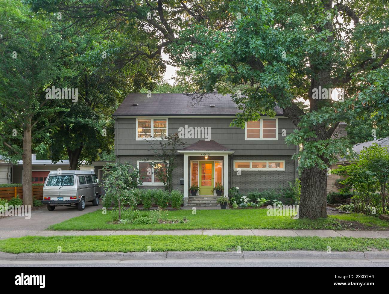Front of garrison colonial house with camper van parked in driveway ...