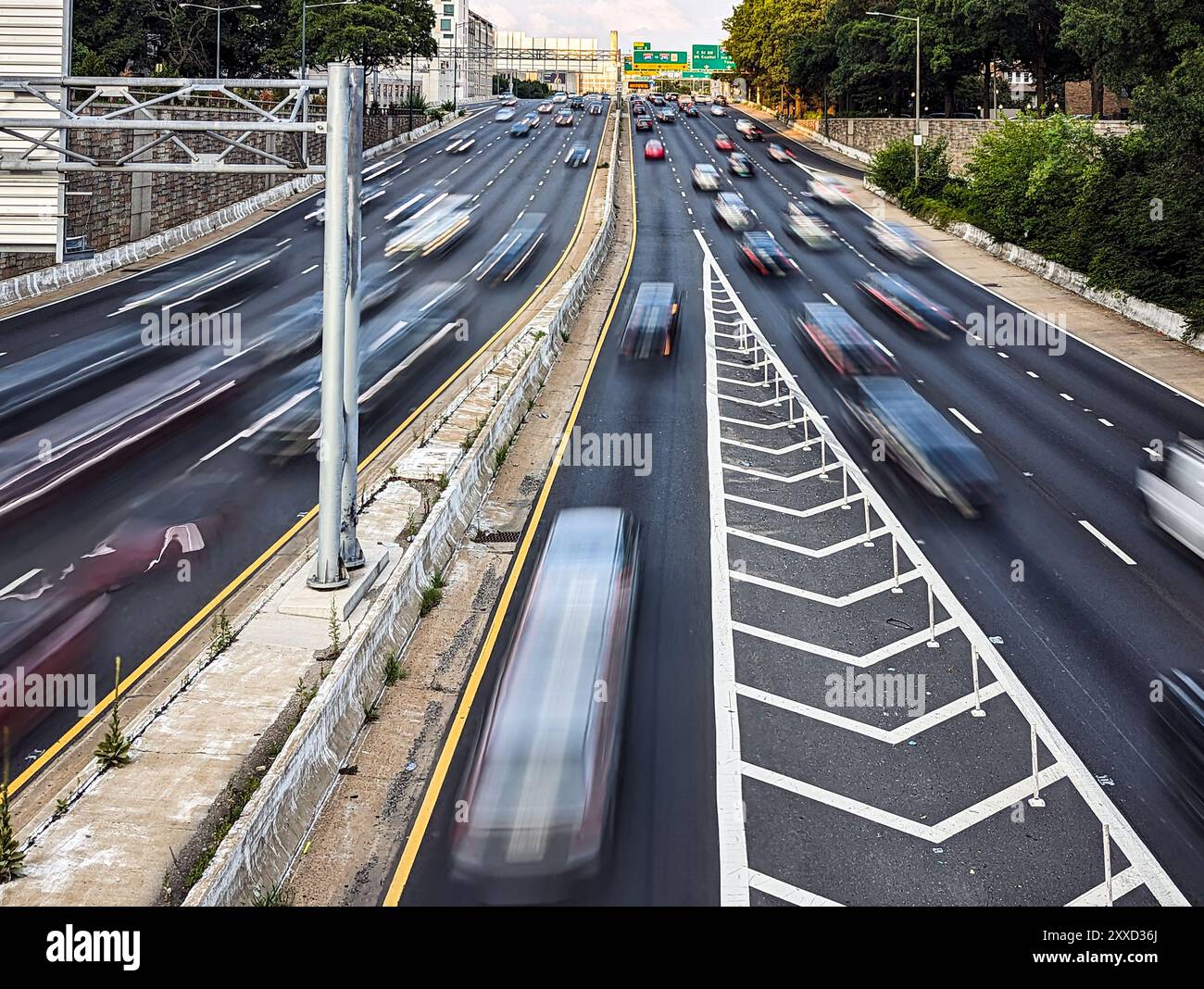Cars driving down the highway with motion blur effect through rush hour ...