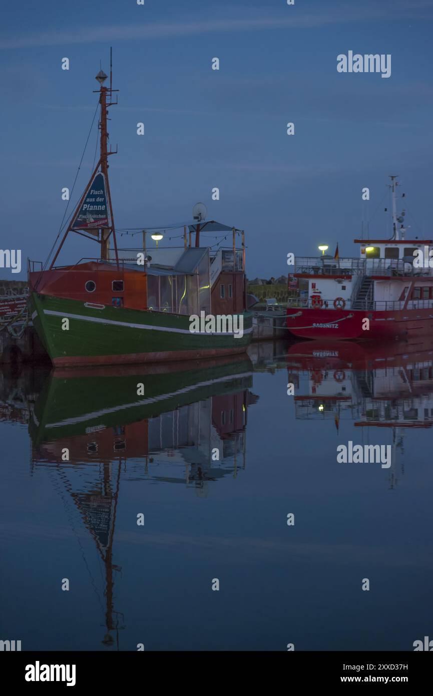 Fishing boat with reflection at the pier Stock Photo - Alamy