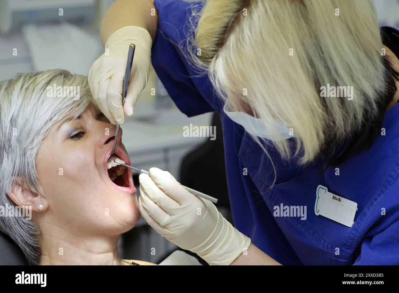 Dental assistant checking teeth Stock Photo - Alamy