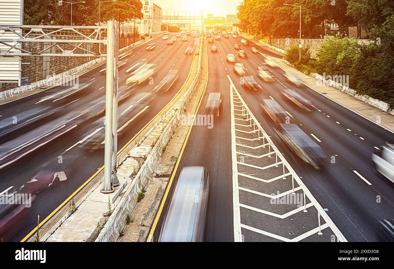 Cars driving down the highway with motion blur effect through rush hour ...