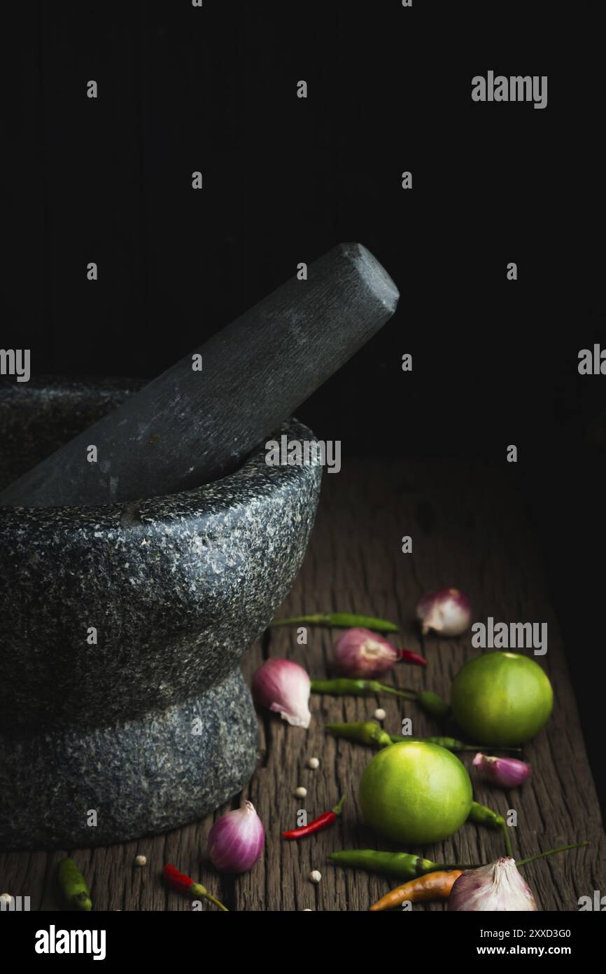 Shrimp paste chilli sauce in a mortar stone with Ingredients to cook ...