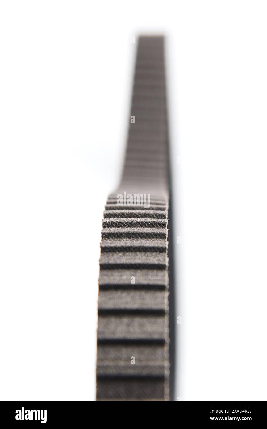 Black new timing belt for gasoline engine on a white isolated ...