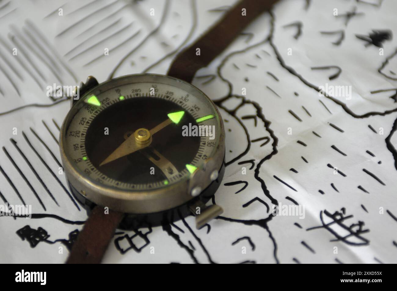 Conceptual stock photo of a Vintage magnetic compass with illuminating ...