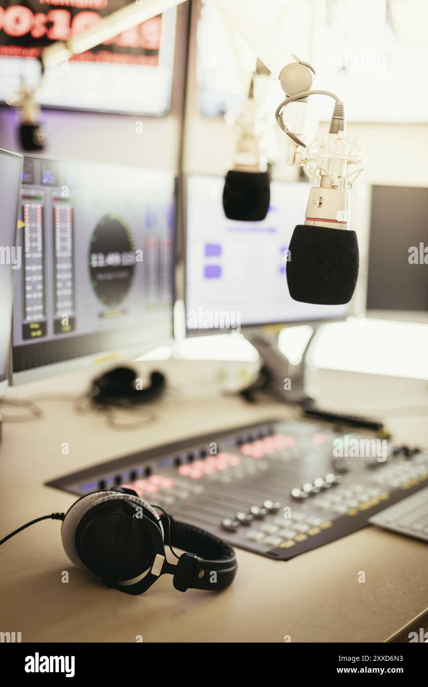 Studio microphone in a broadcasting radio studio, mixer and computer in ...