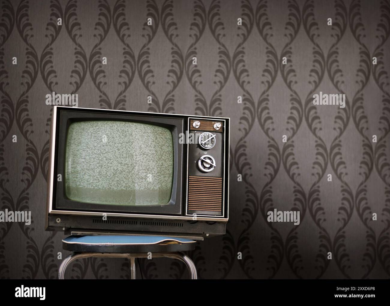 Old television in front of wallpaper Stock Photo - Alamy
