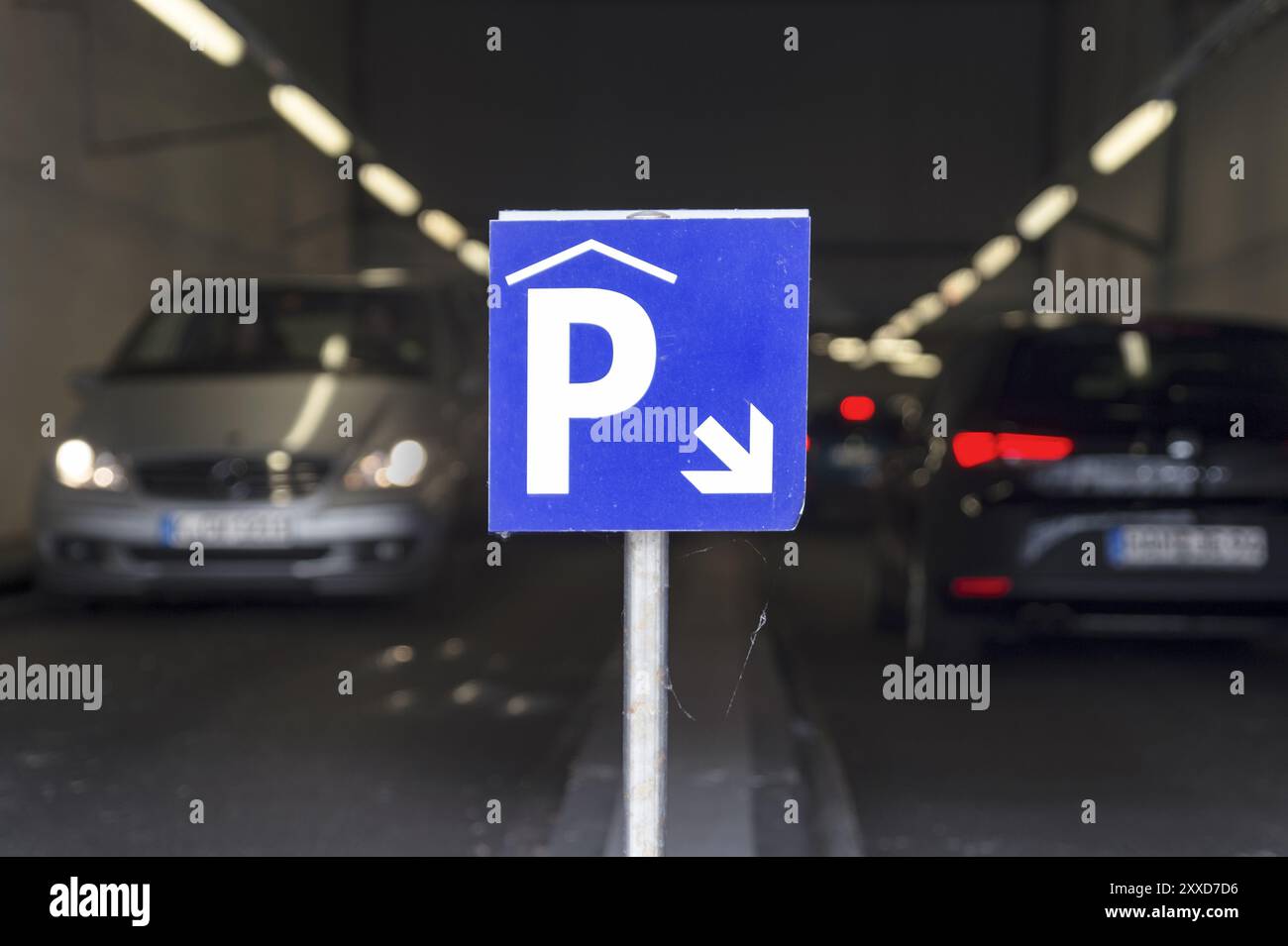 Entry and exit of a multi-storey car park with cars driving in and out ...
