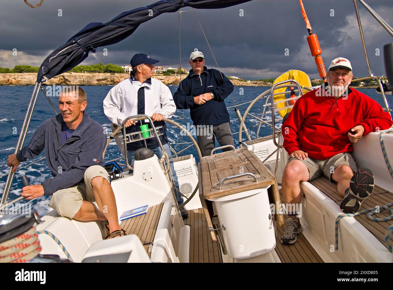 4 men on a sailing yacht Stock Photo - Alamy