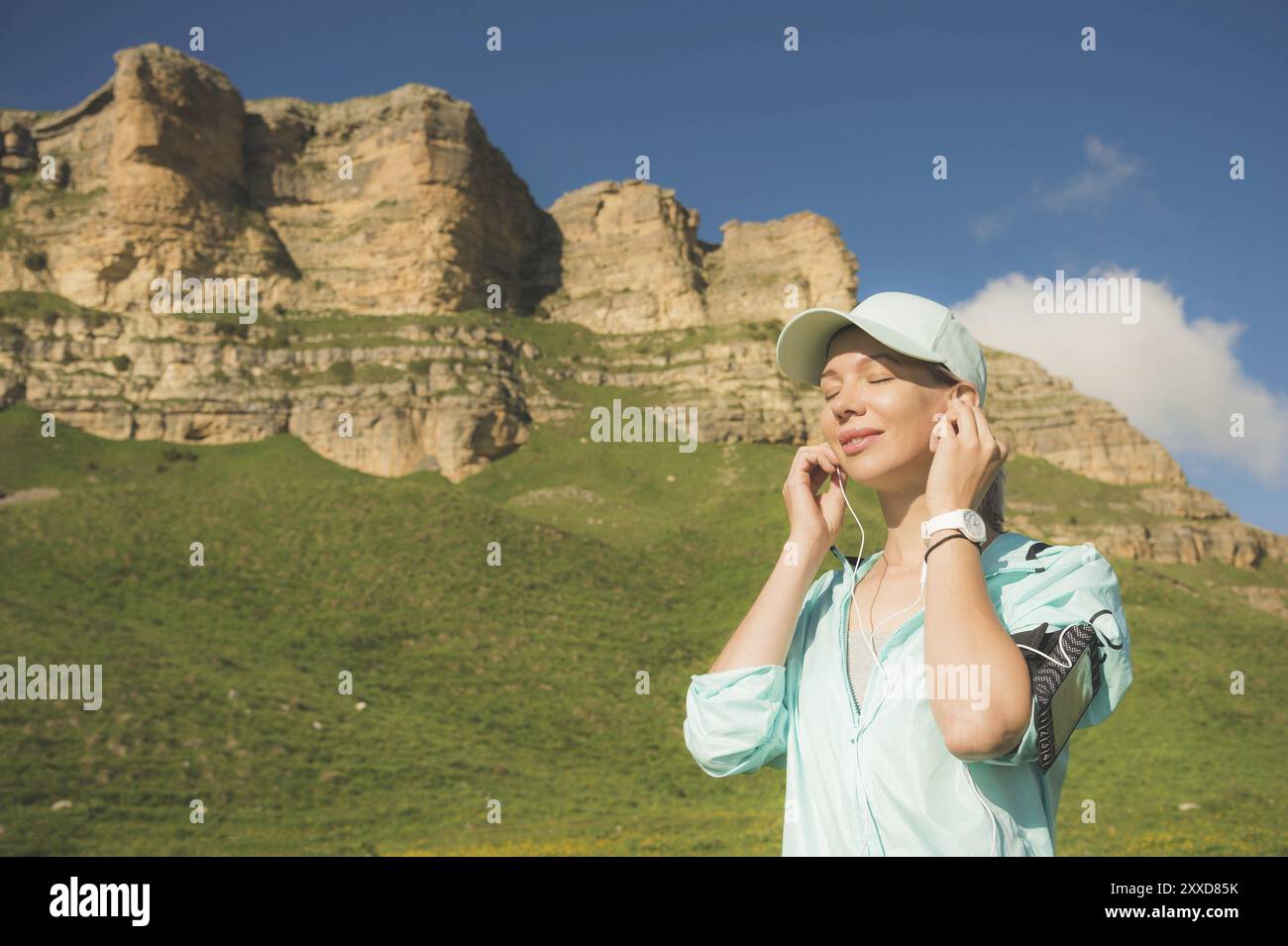 Fitness runner woman closing his eyes listening to music on the nature ...
