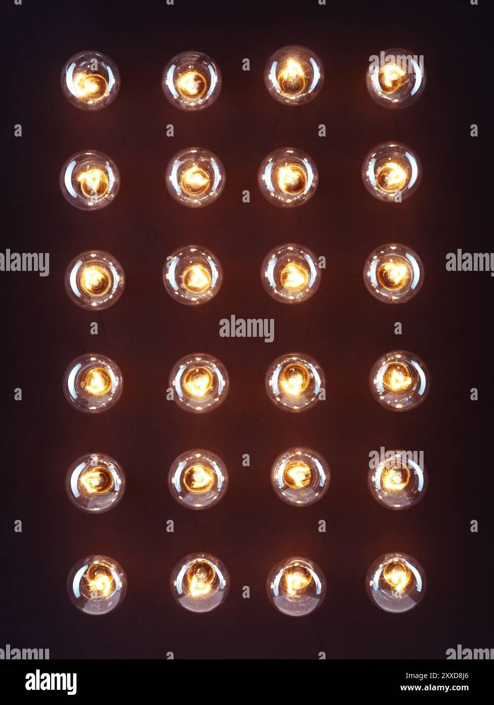 A group of illuminated incandescent light bulbs shining isolated on ...