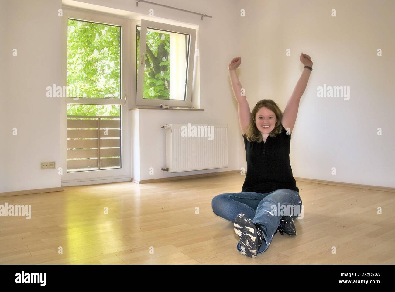 Young woman in her first own flat Stock Photo - Alamy