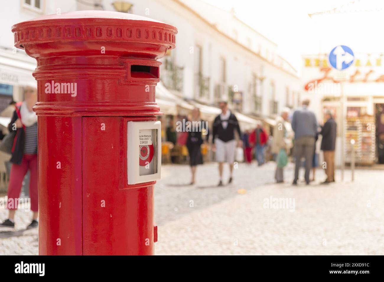 Red letterbox in the city centre Stock Photo - Alamy