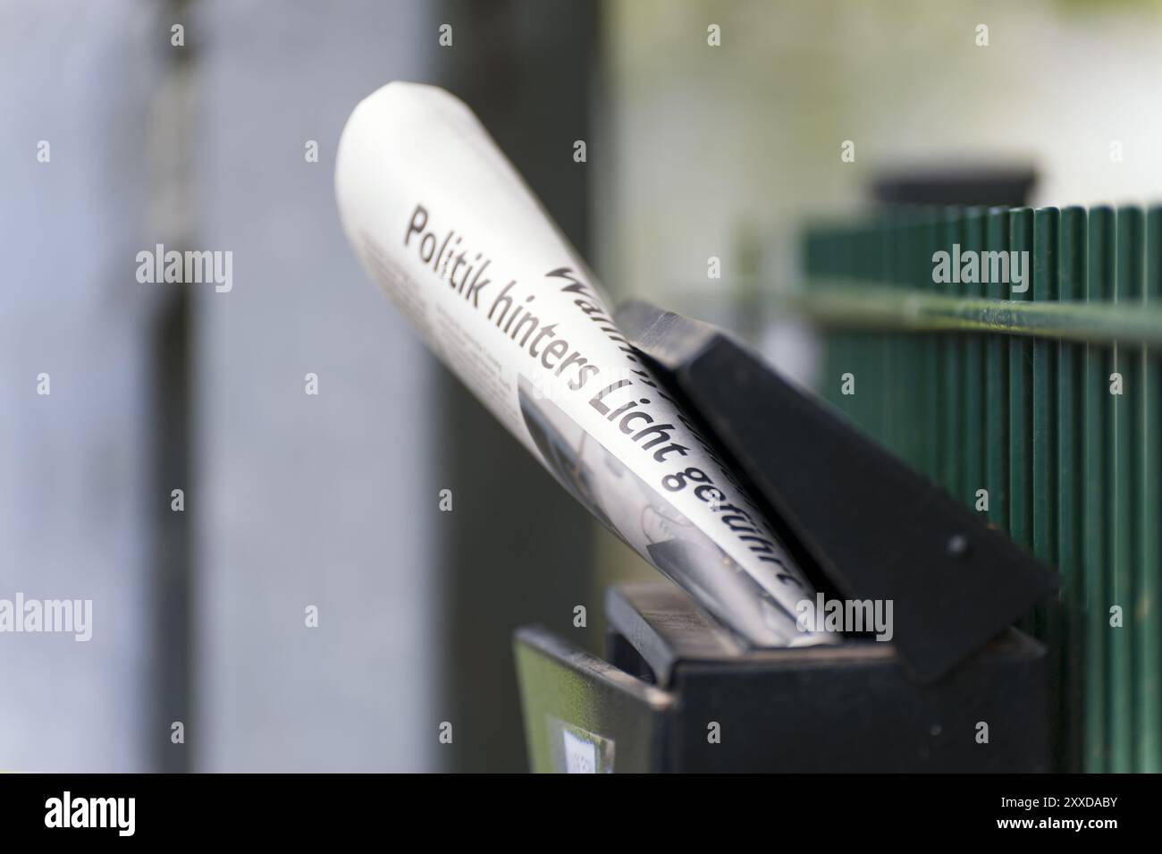 Daily newspaper stuck in a letterbox Stock Photo - Alamy