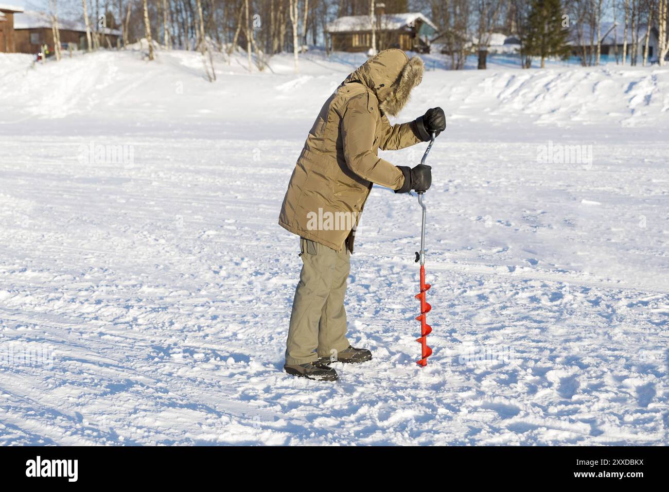 Ice fishing in the frozen river Ivalojoki, Ivalo, Finland, Europe Stock ...