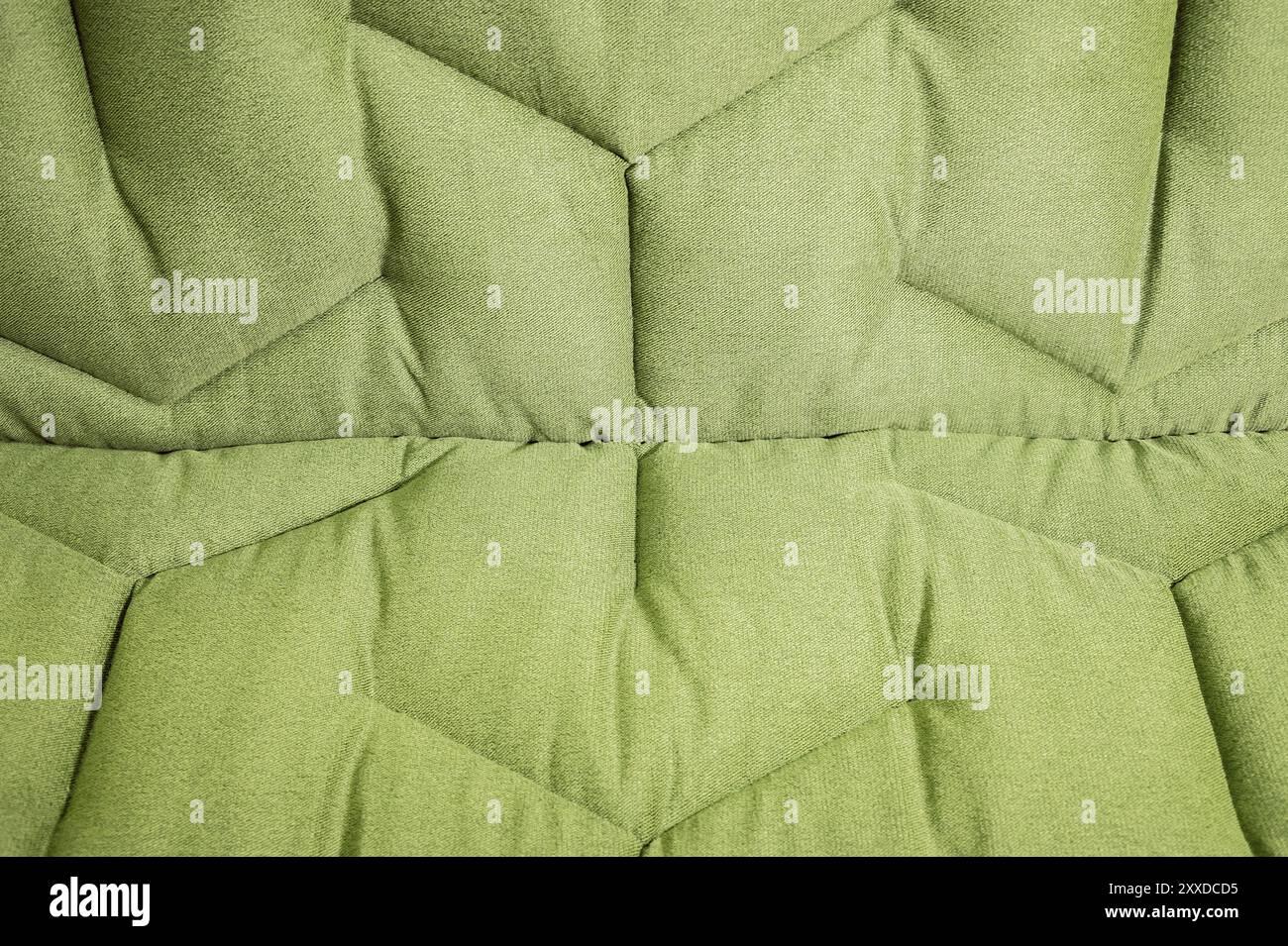 Close-up comfortable green soft sofa with curly stitching. Modern ...