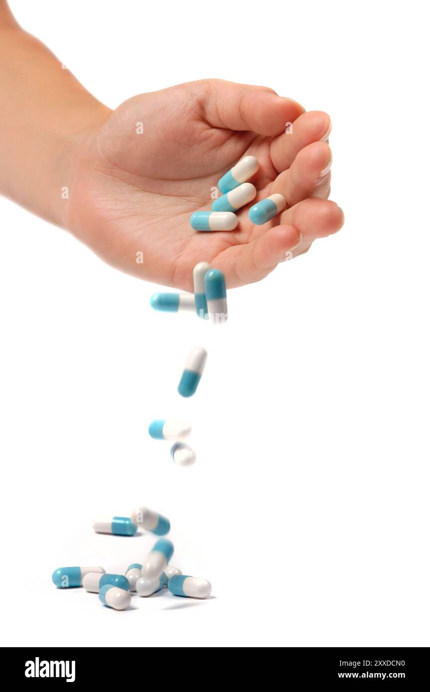 White medical capsules fall from hi-res stock photography and images ...