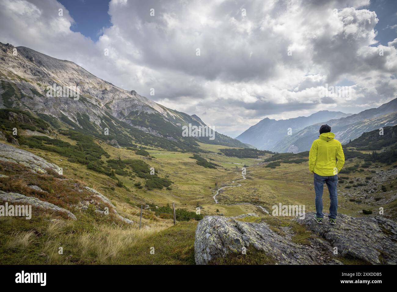 Male mountain climber with backpack is enjoying the view Stock Photo ...