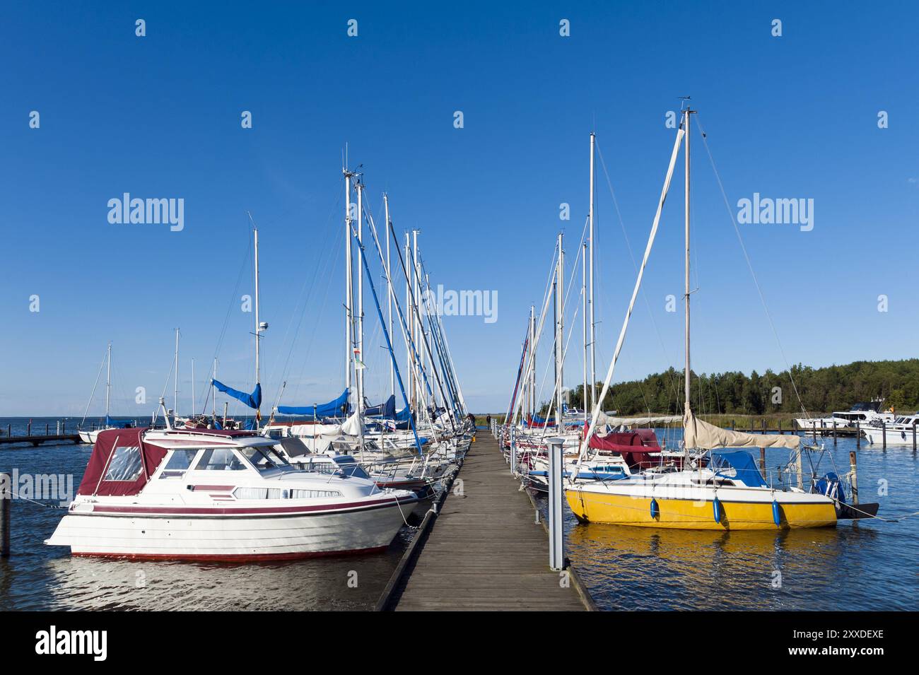 Jetty with sailing boats in the sunshine Stock Photo - Alamy