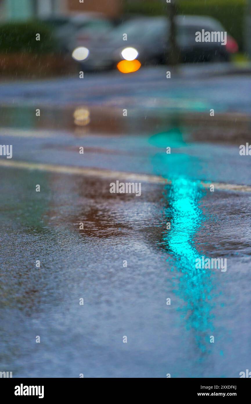 Road traffic Reflection of the green phase of a traffic light at a ...