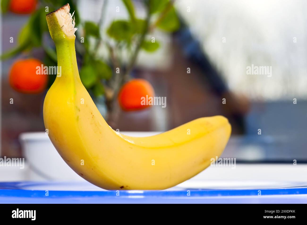 Ripe banana lying on the table in front of the kitchen window Stock ...