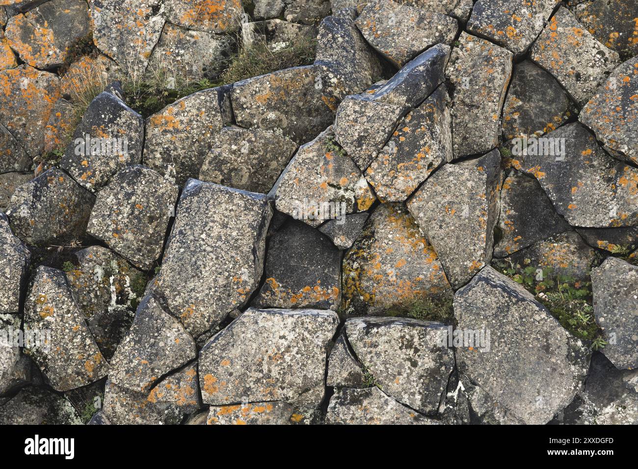 Textured basalt background hexagonal stone pillars in a section ...