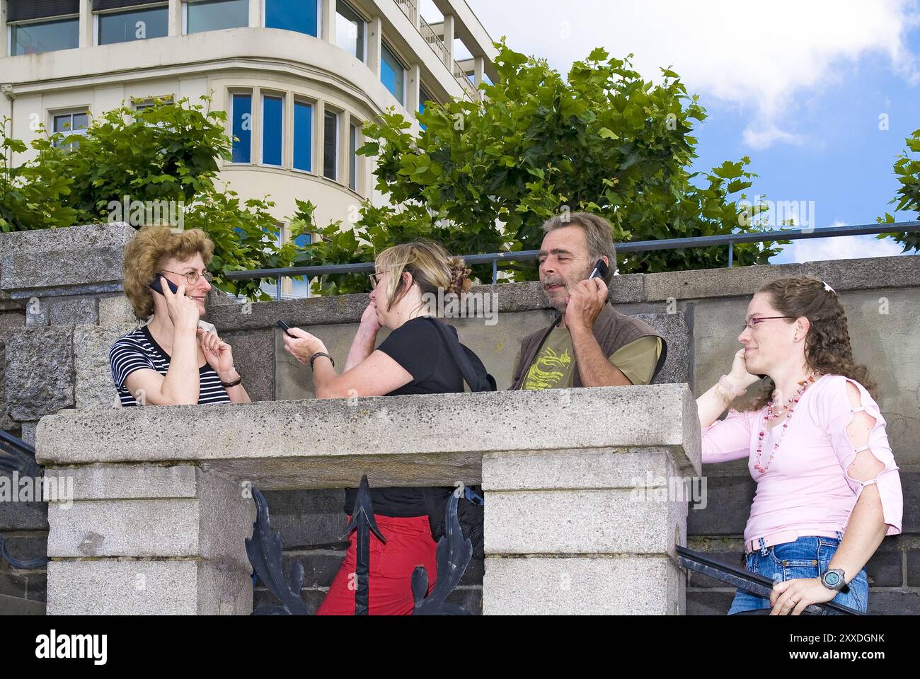 4 people on the phone Stock Photo - Alamy