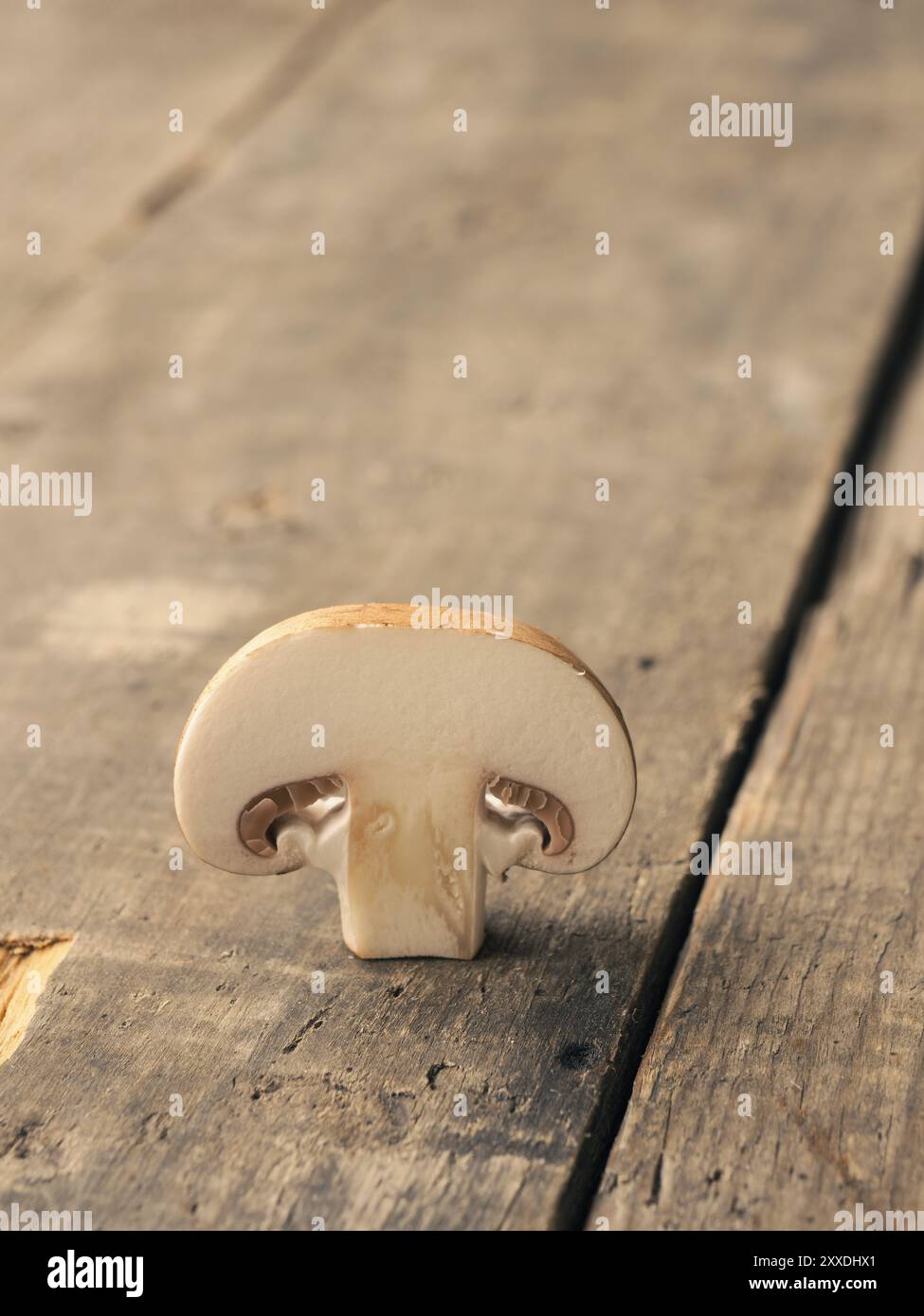 One slice of a mushroom on a rustic wooden kitchen table, healthy ...