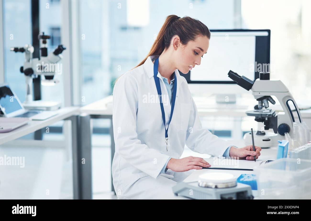 Microscope, scientist and writing notes in research laboratory for ...
