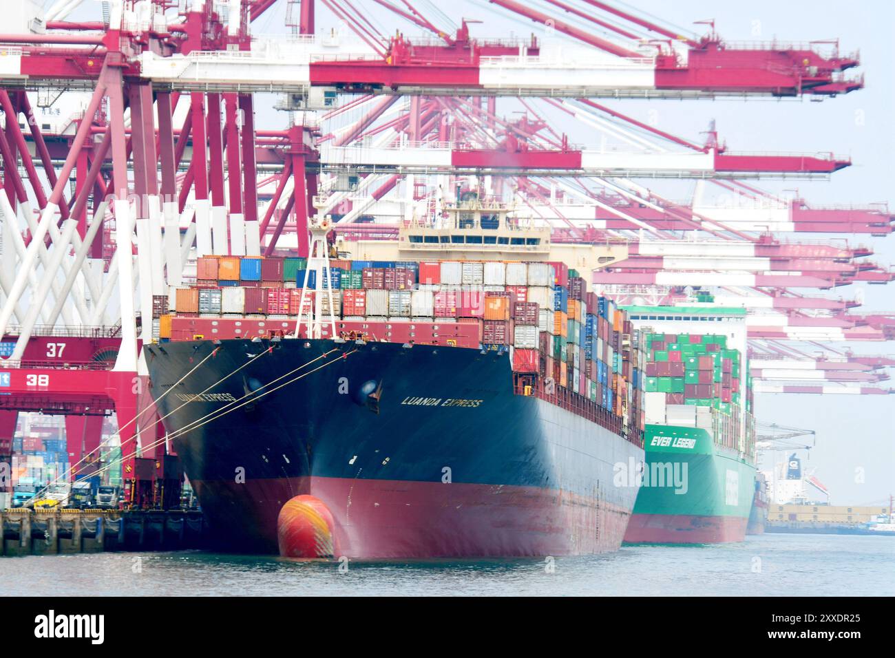 QINGDAO, CHINA - AUGUST 23, 2024 - Cargo ships load and unload ...