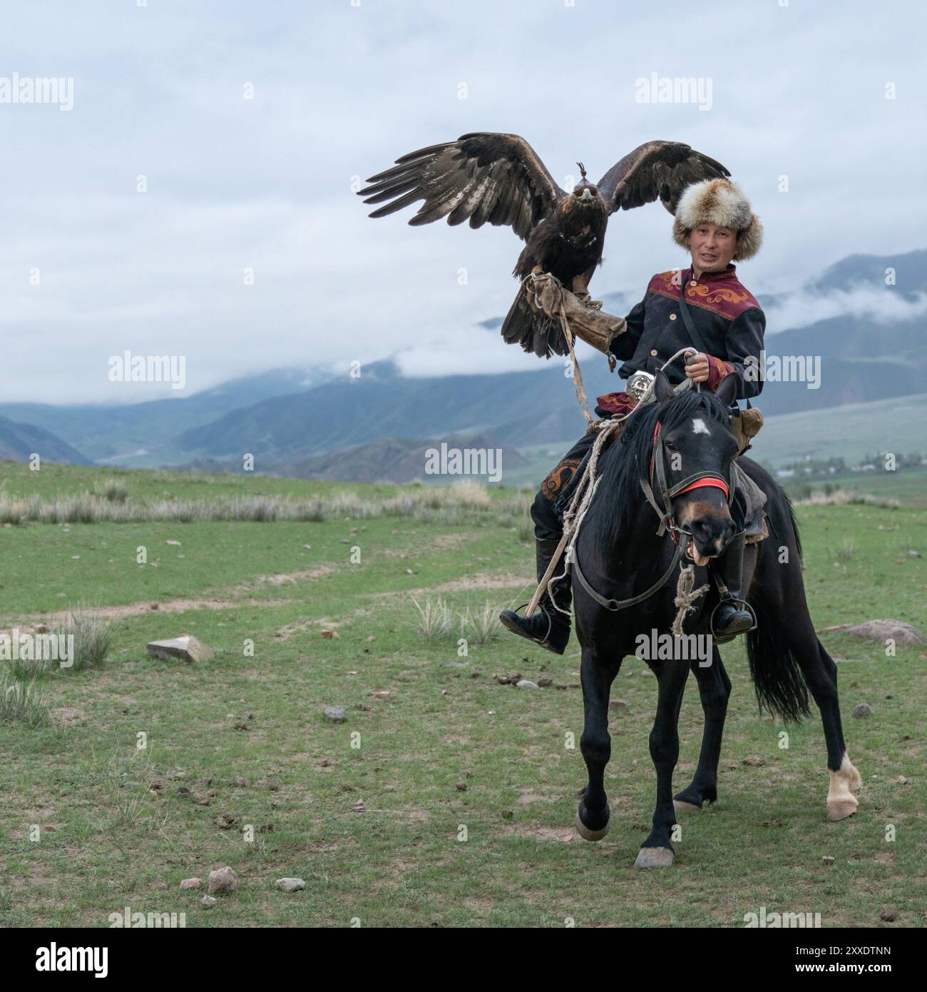 Issyk Kul, Kyrgyzstan - 23 May 2022: Eagle trainer on horseback with ...
