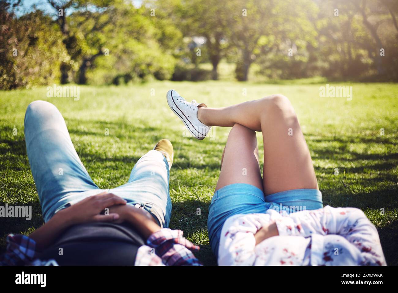 Couple, park and legs in nature with love, bonding and commitment ...