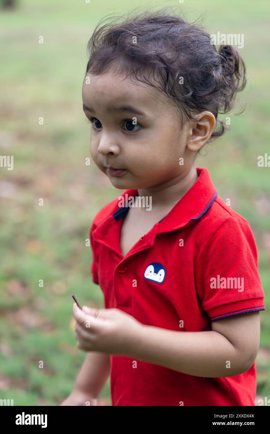 isolated indian kid walking at outdoor park at evening from flat angle ...