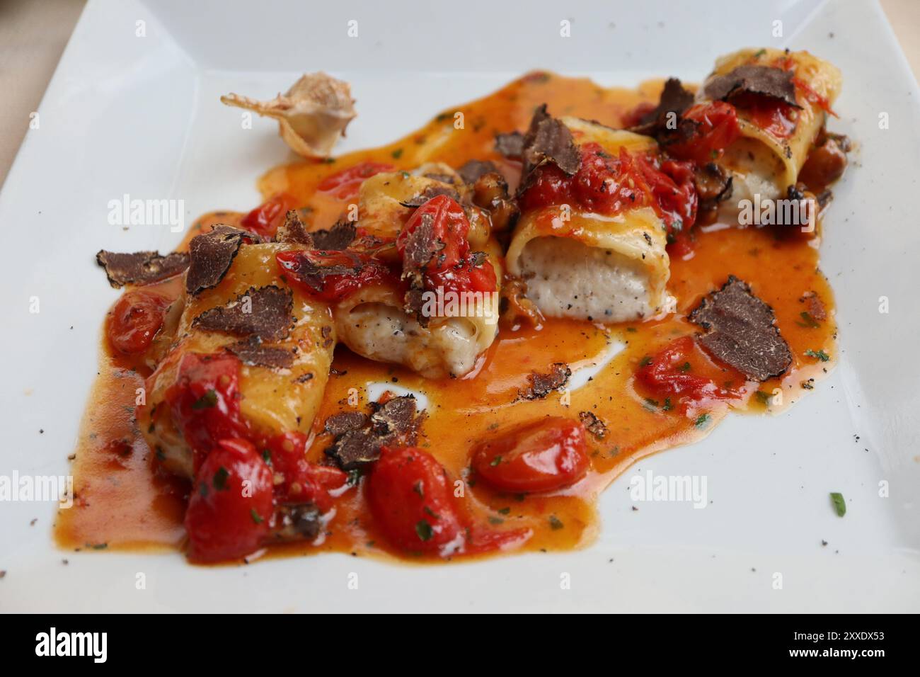 Italian cuisine: pasta with seafood sauce, goat cheese and black ...