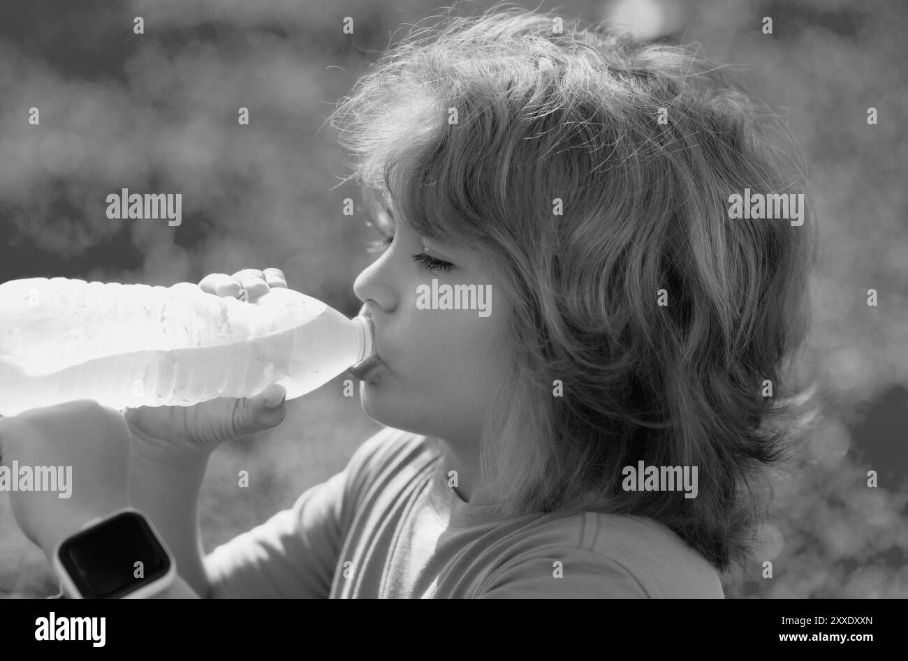 Kid drinking water. Portrait of little child with bottle of fresh water ...